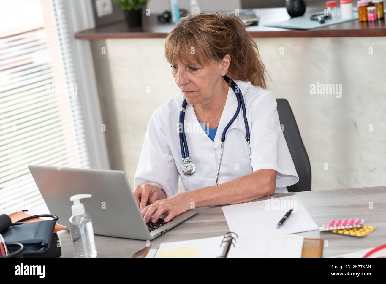 Female doctor using laptop in medical office Stock Photo - Alamy