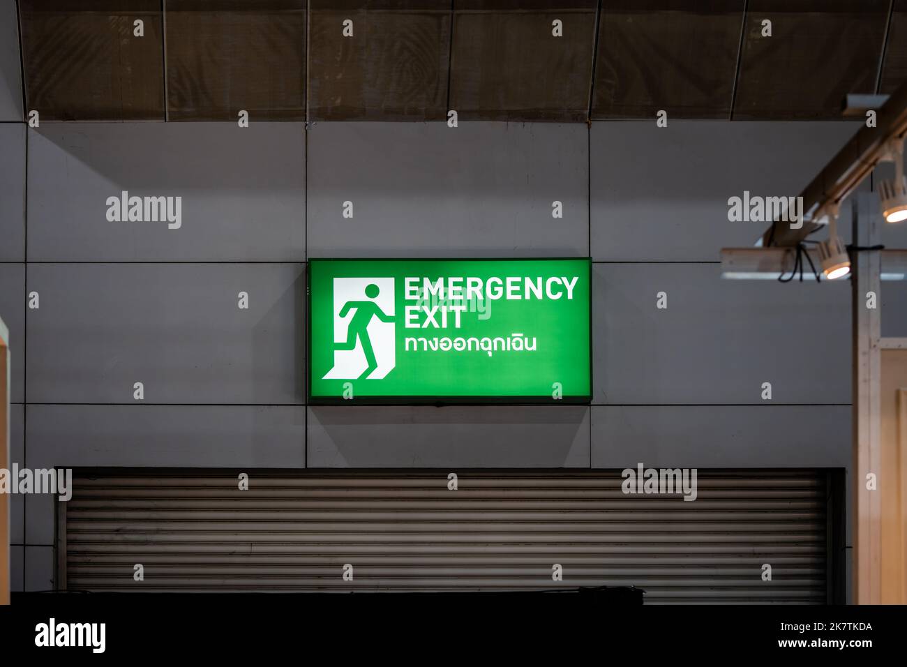 Large Emergency exit sign green light box is placed on the wall of ...