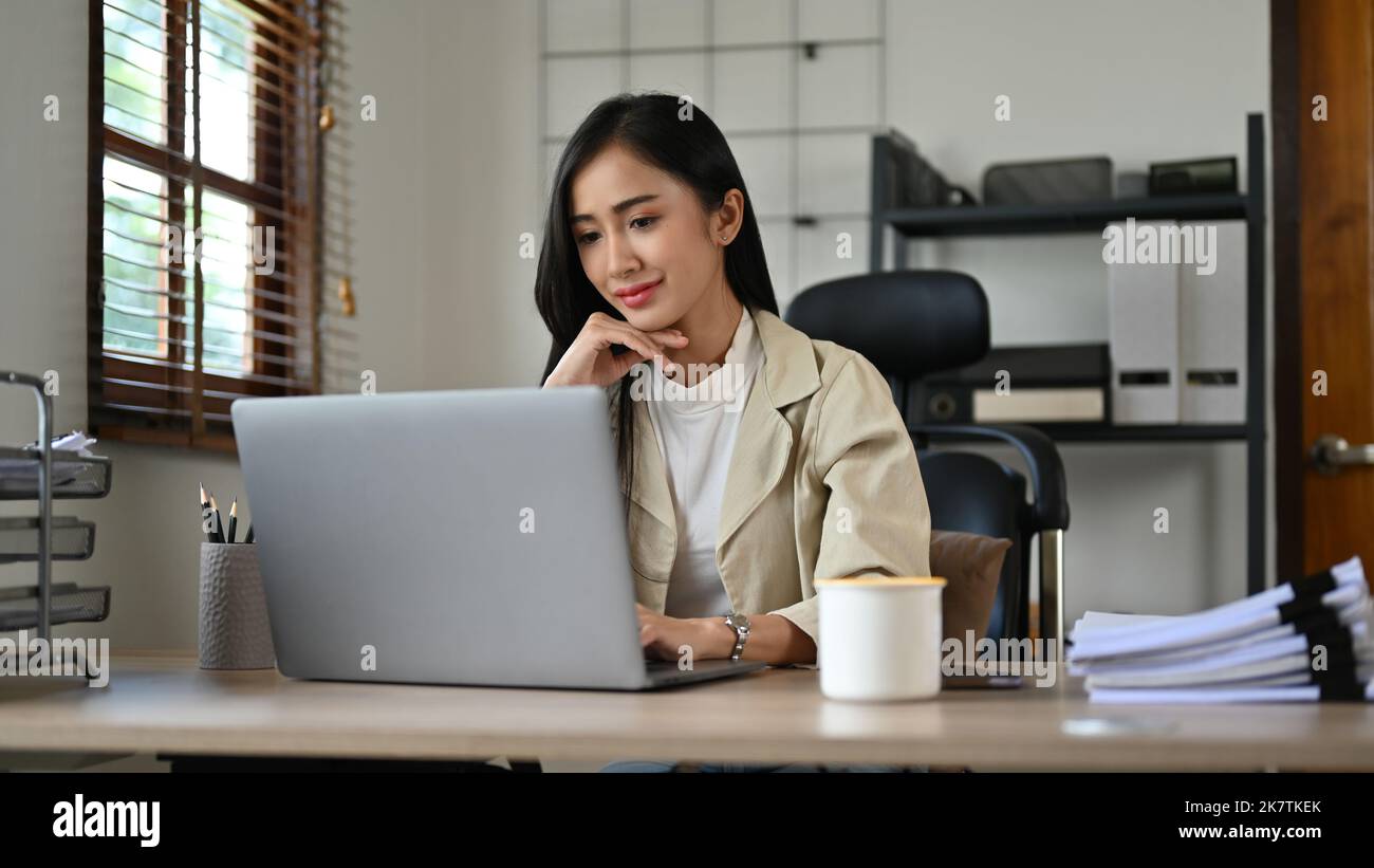 Gorgeous and successful millennial Asian businesswoman or female boss ...