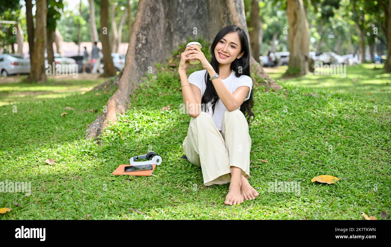 Beautiful Young Asian Female Chilling In The City Park On Her Weekend