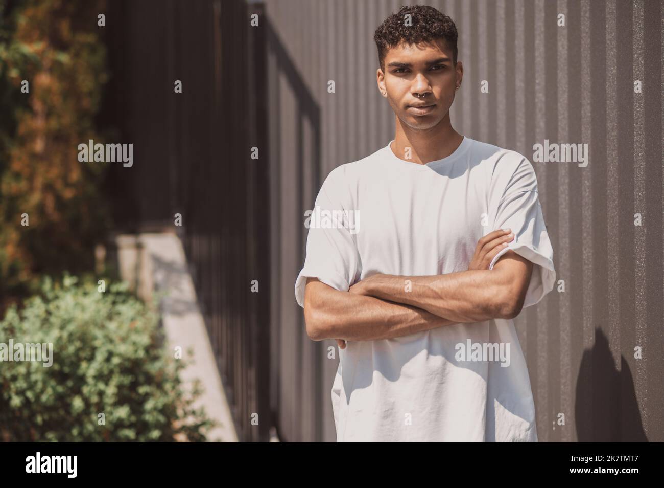 Young guy in white tshirt looking confident Stock Photo - Alamy