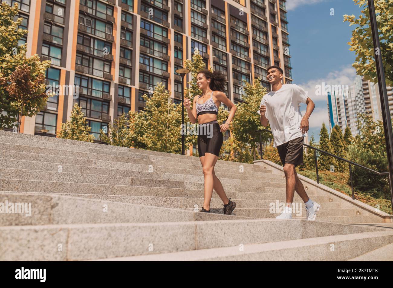 Two young people having a run together Stock Photo - Alamy