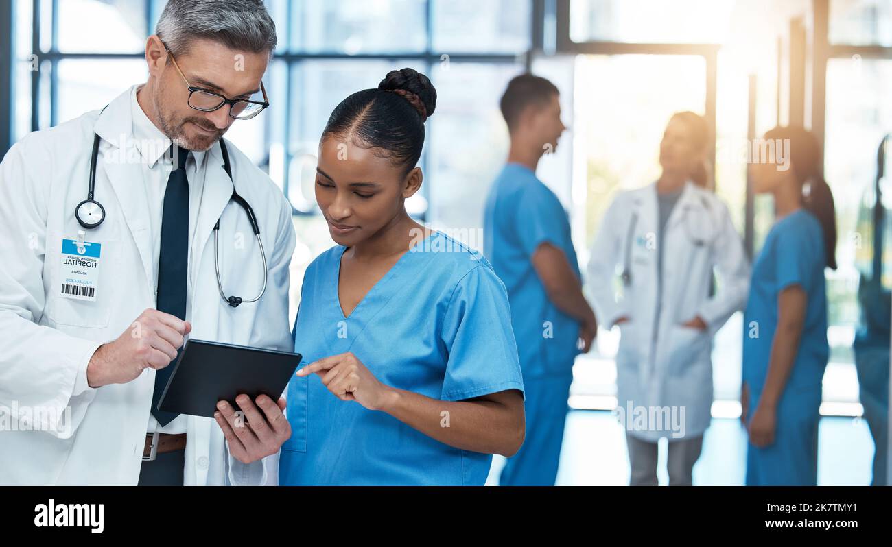 Doctor, healthcare and research with nurse on tablet in collaboration for diagnosis or ...