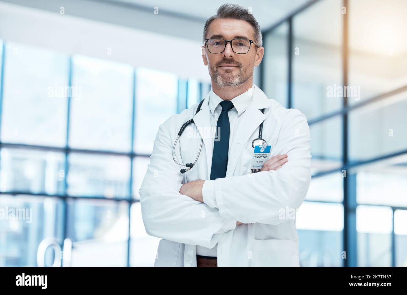 Doctor, senior man and arms crossed with glasses and stethoscope in ...