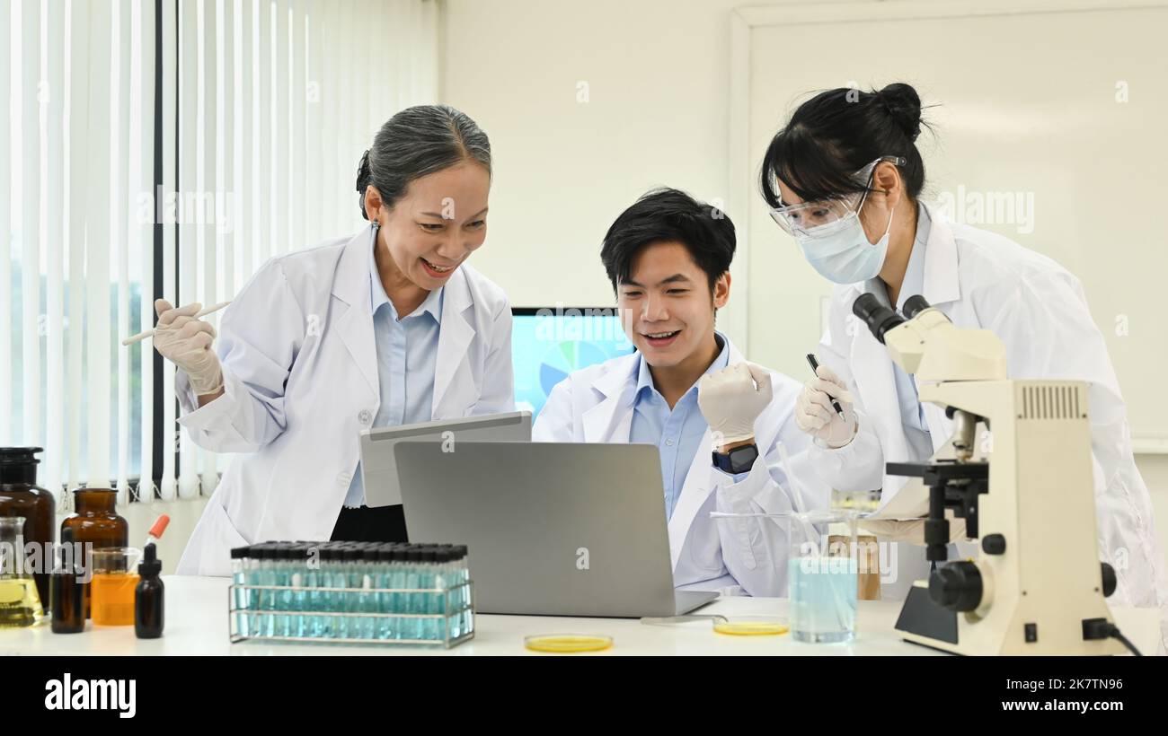 Professional researchers team celebrating success results of the ...