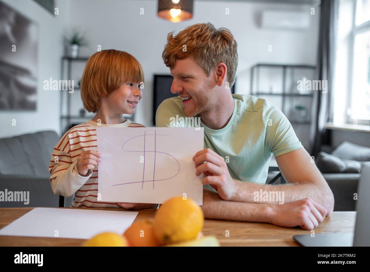 Dad and son feeling playful and looking happy Stock Photo - Alamy