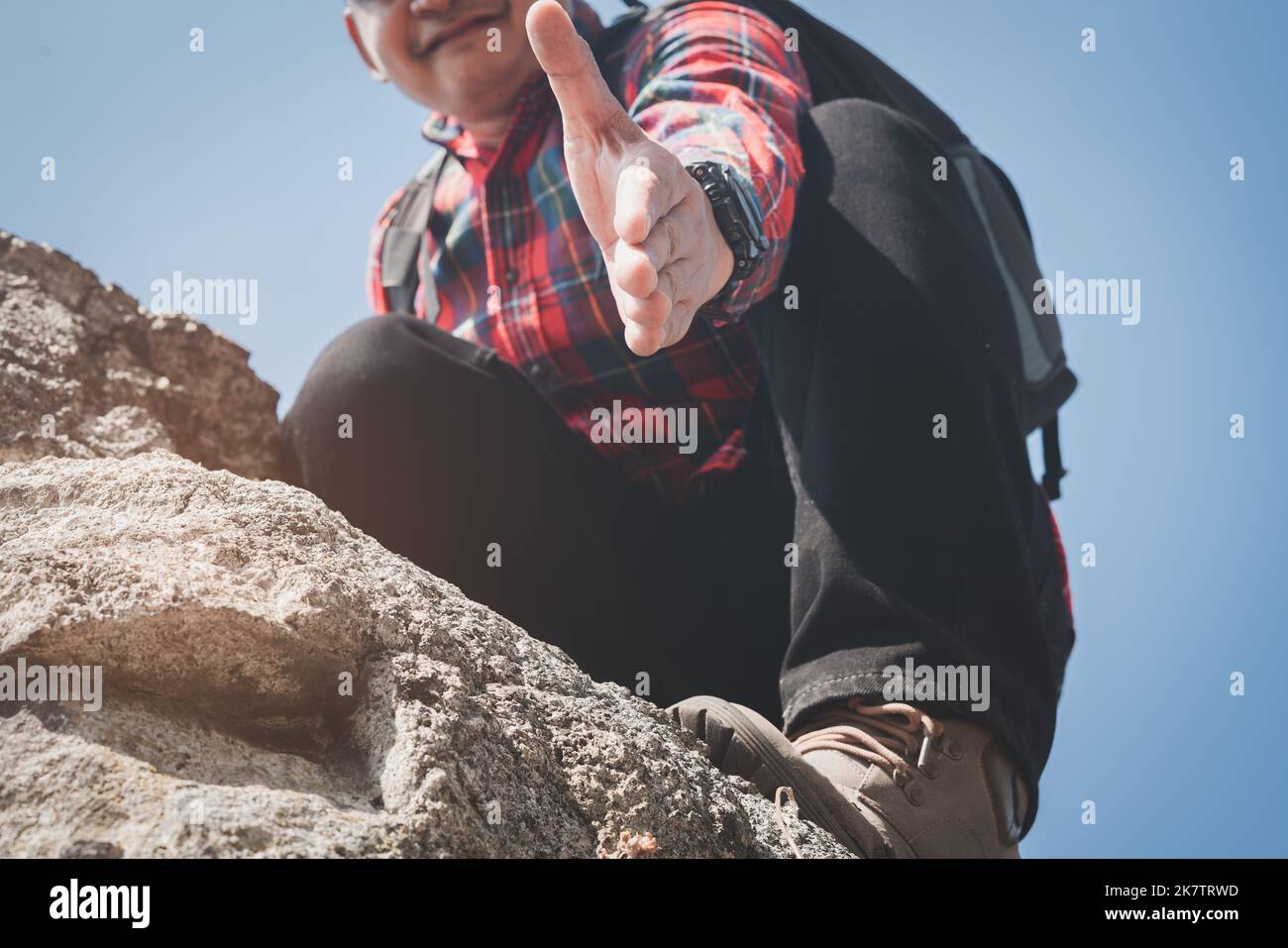 Hiker man giving a helping hand, Hands reaching out to help each other ...