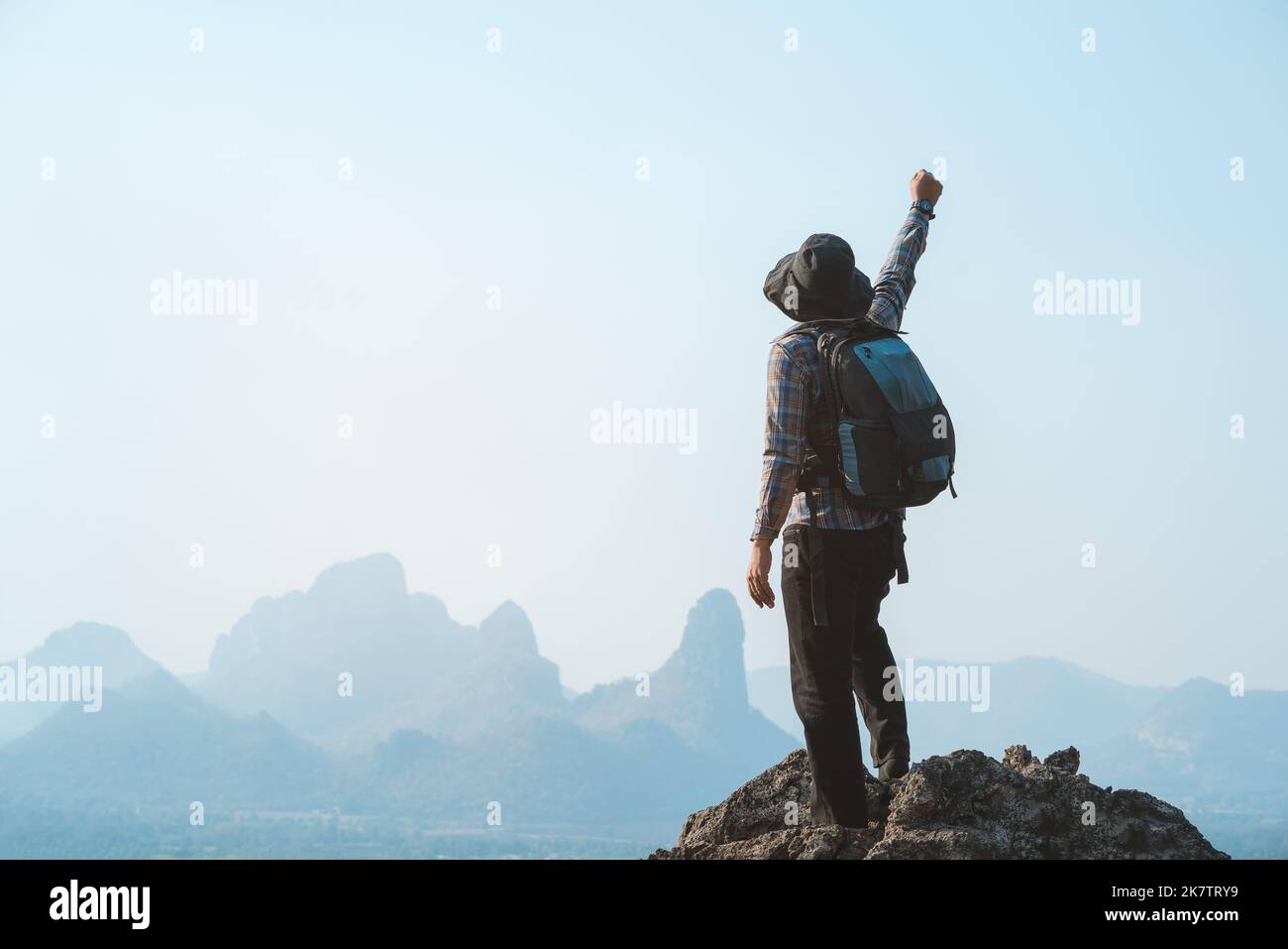Success man hiker outstretched arms stand at cliff edge on mountain top.Concept of adventure ...