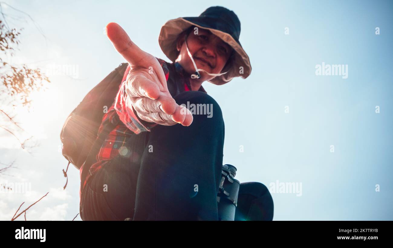 Hiker man giving a helping hand, Hands reaching out to help each other ...