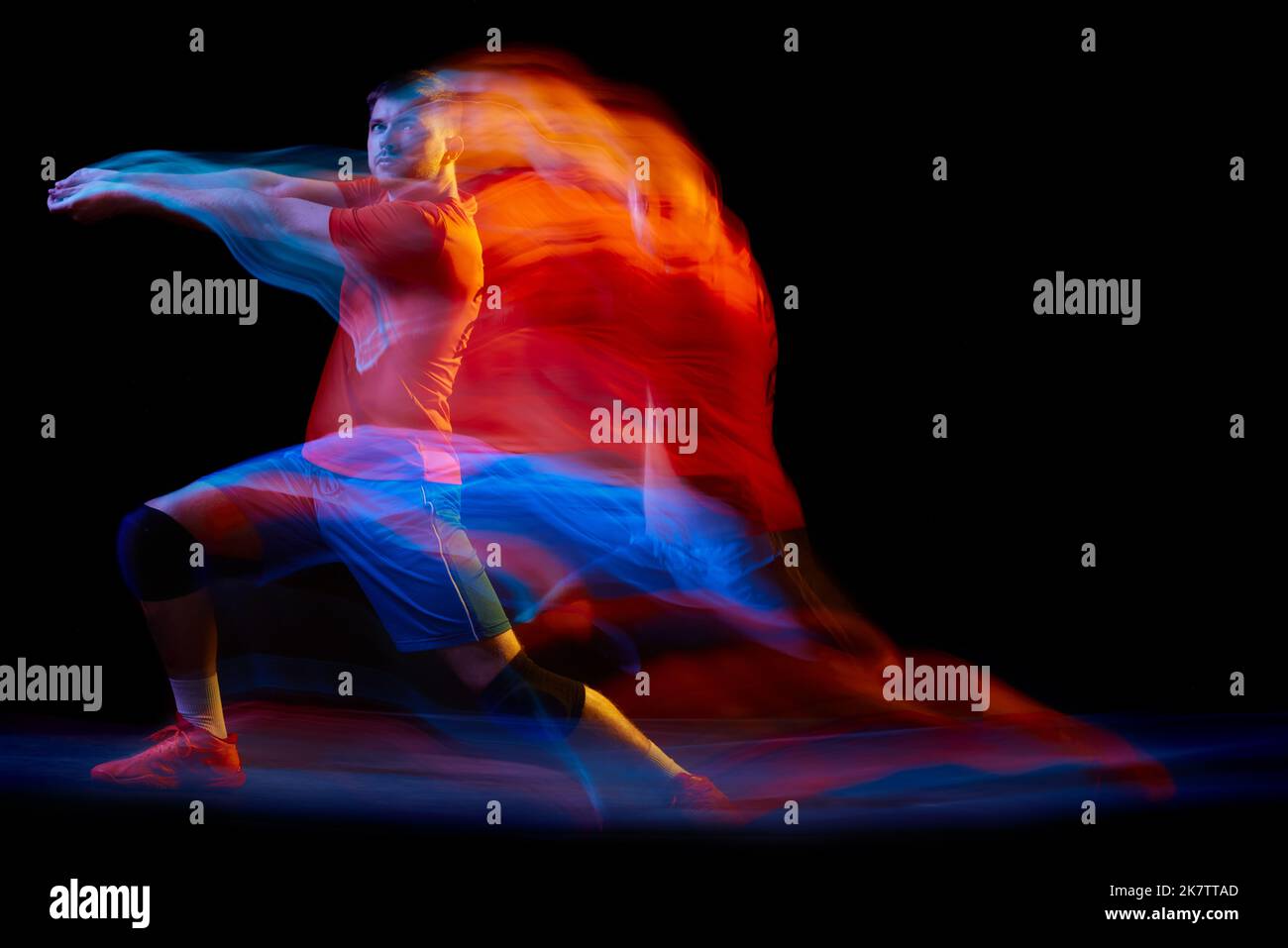 Athlete in motion. Young volleyball player in action isolated on dark ...