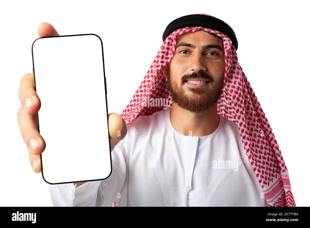Young Arab muslim man in traditional clothes showing mobile phone ...