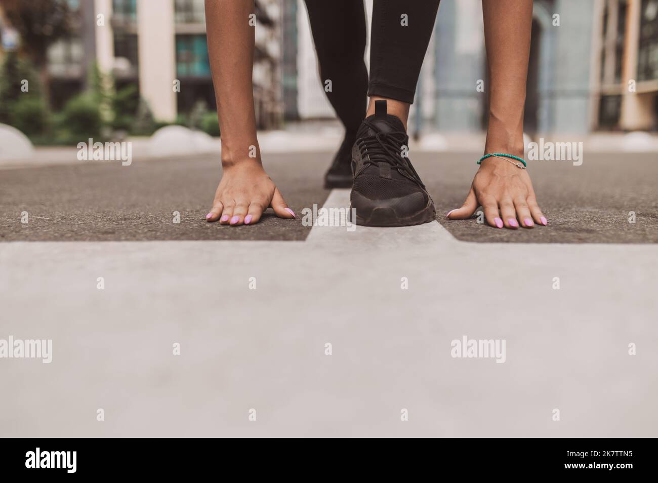 Female runner standing on the start and looking ready to to start Stock ...