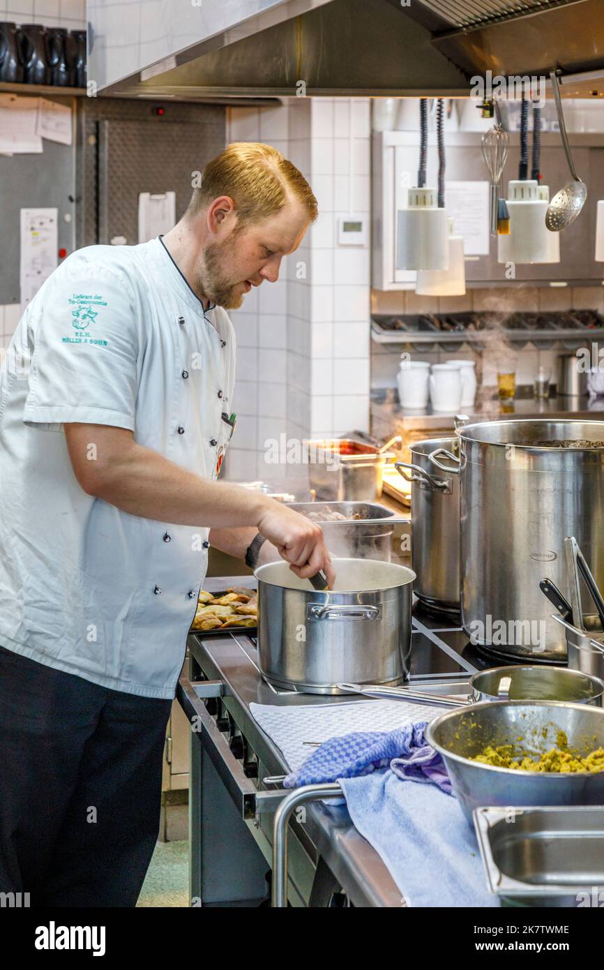Chef preparing food in a professional kitchen Stock Photo - Alamy