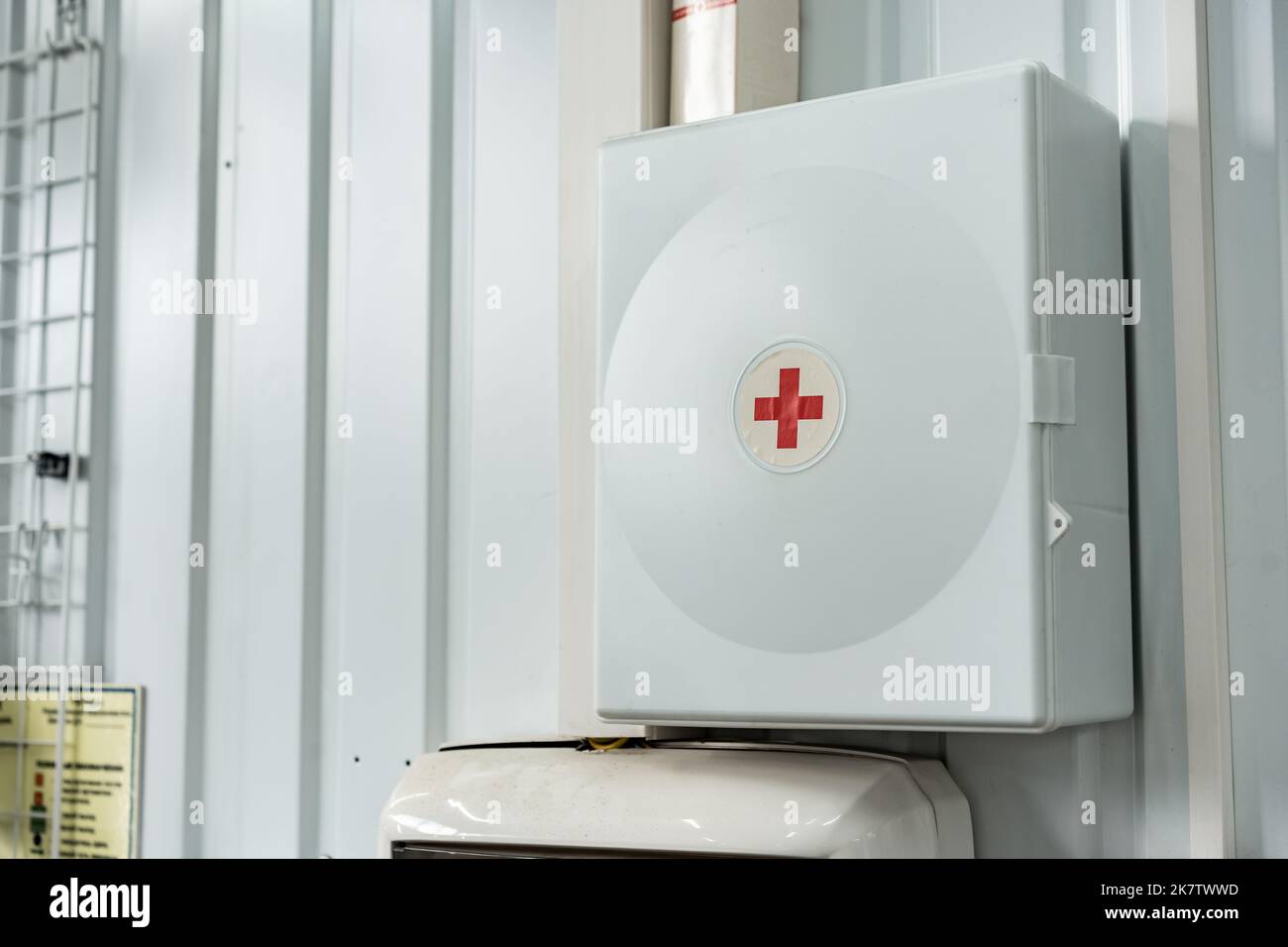 First aid kit hanging on gray metal wall Stock Photo - Alamy