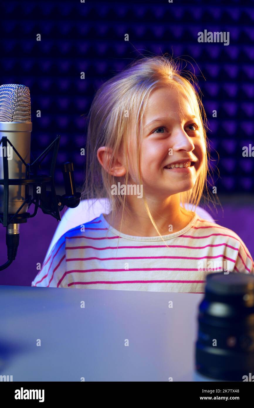 Smiling child girl sitting in recording studio portrait Stock Photo - Alamy