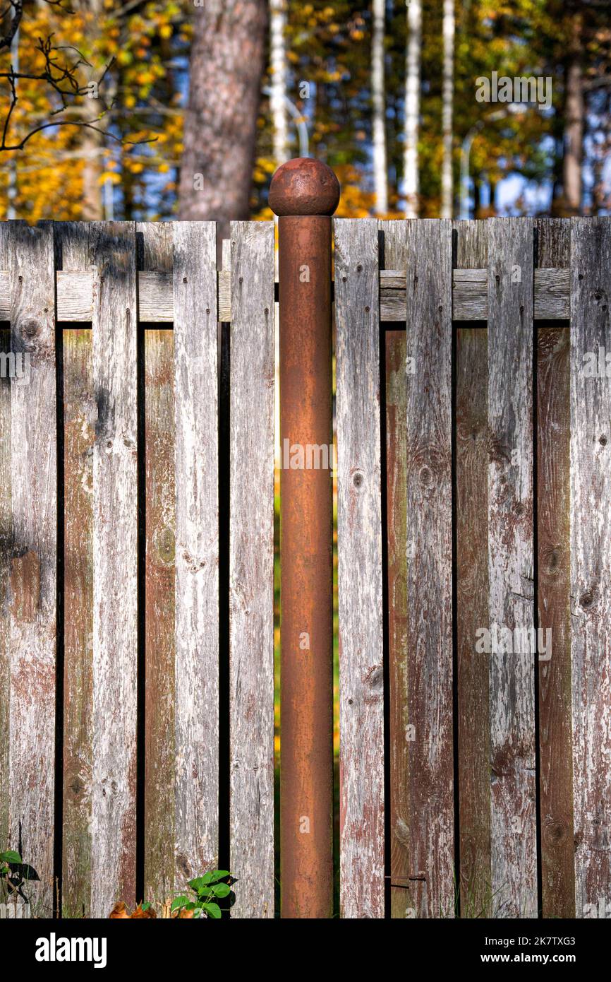 Old wooden fence. The fence is supported by rusty metal posts Stock ...