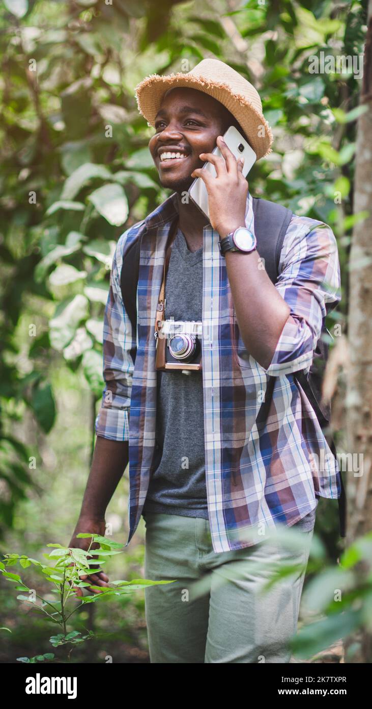 Happy african male tourist speaking by the smartphone Stock Photo - Alamy