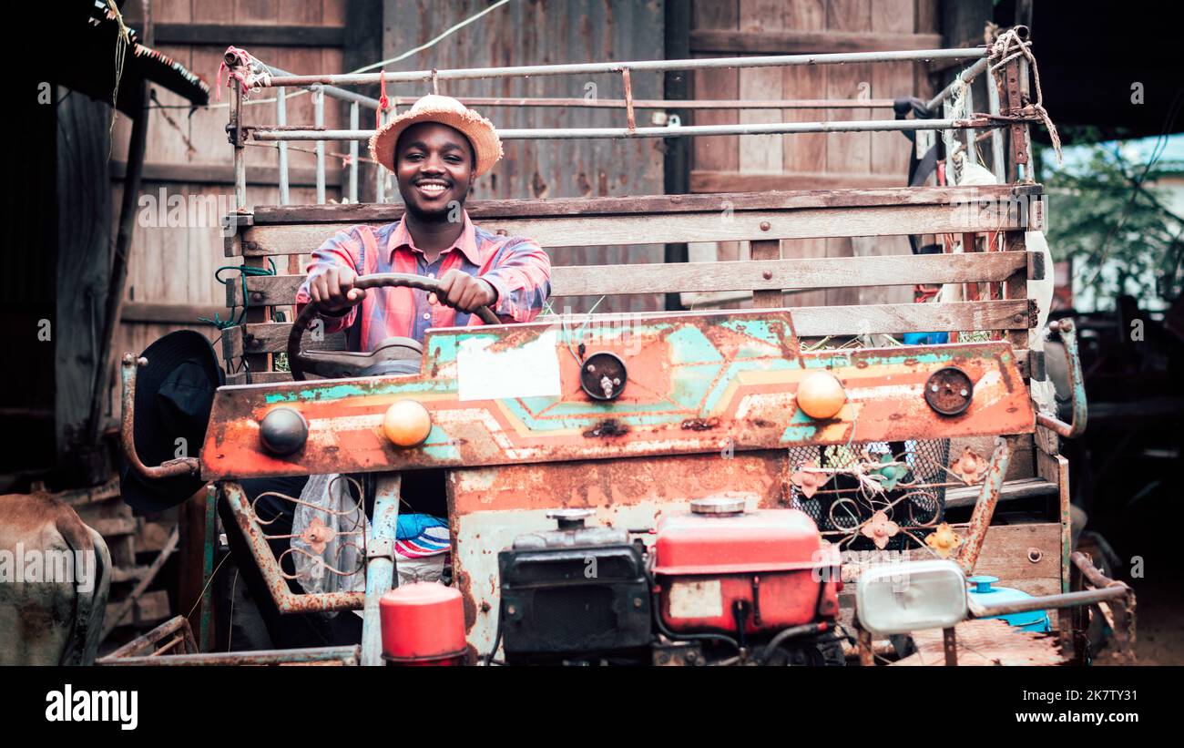 African farmer drives a tractor to farm with a smiling face Stock Photo ...