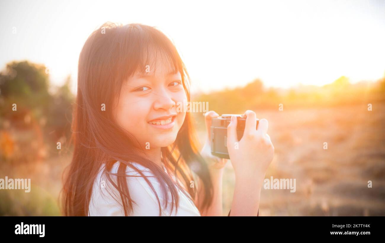Young girl practicing photography in beautiful natural light Stock ...