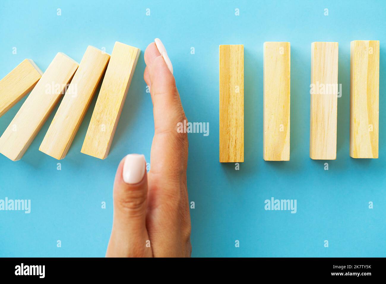 Hand holds wooden blocks, the concept of stopping the crisis Stock ...