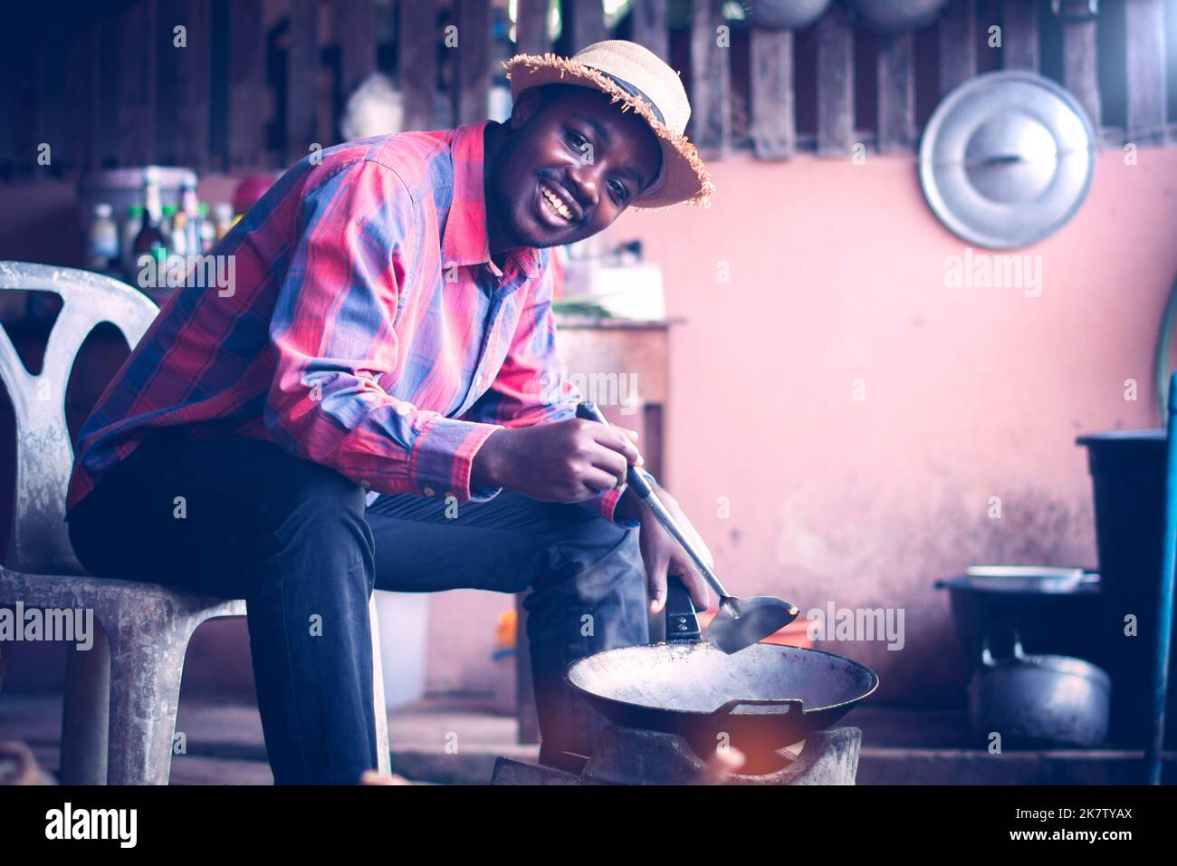 Smile Indigenous African man cooking in a rural kitchen Stock Photo - Alamy