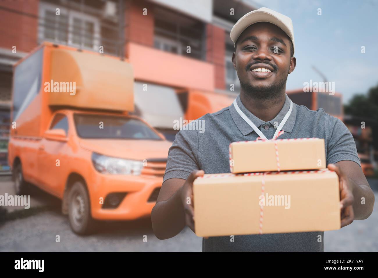 African delivery man holding a box package and cardboard.Concept of ...