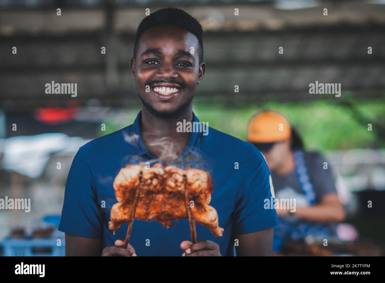 African man seller selling grilled chicken stands smiling happily Stock ...