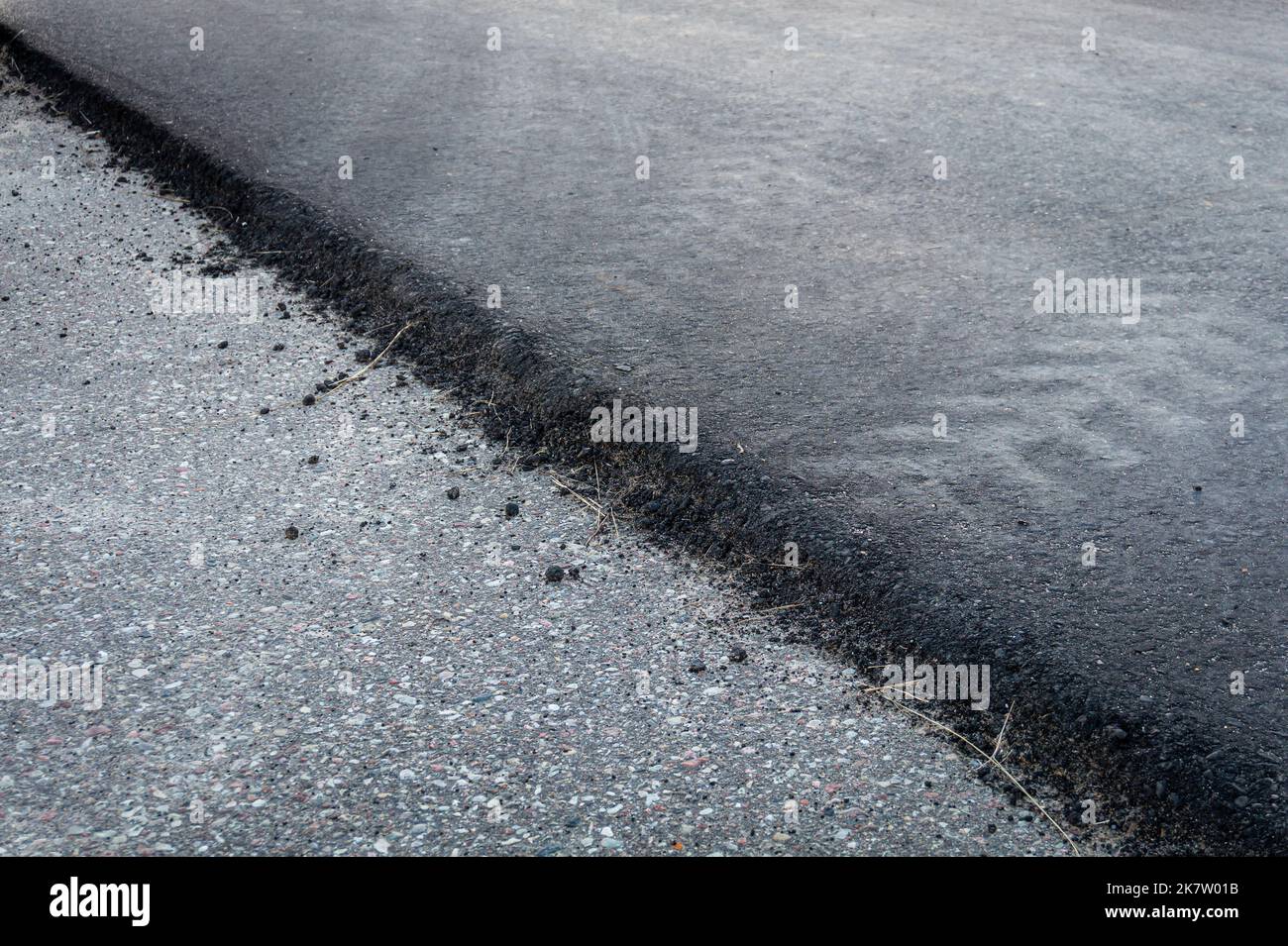 Fresh black and old grey asphalt layers on road surface texture ...