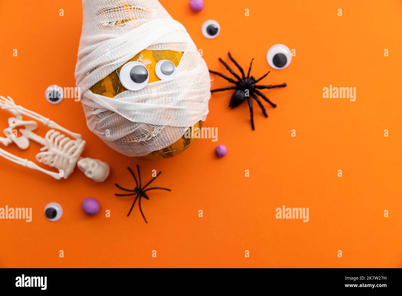 Cute halloween background with mummy pumpkins, skeletons and spiders ...