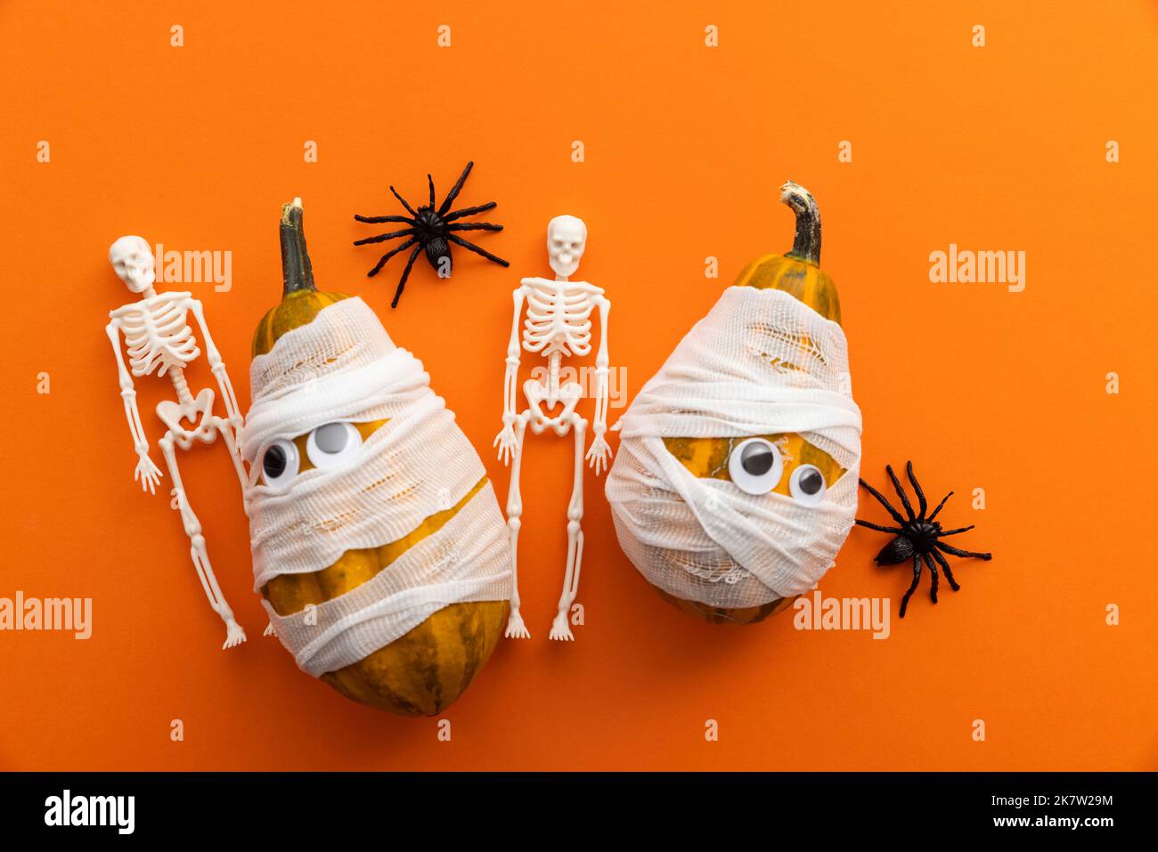 Cute halloween background with mummy pumpkins, skeletons and spiders ...