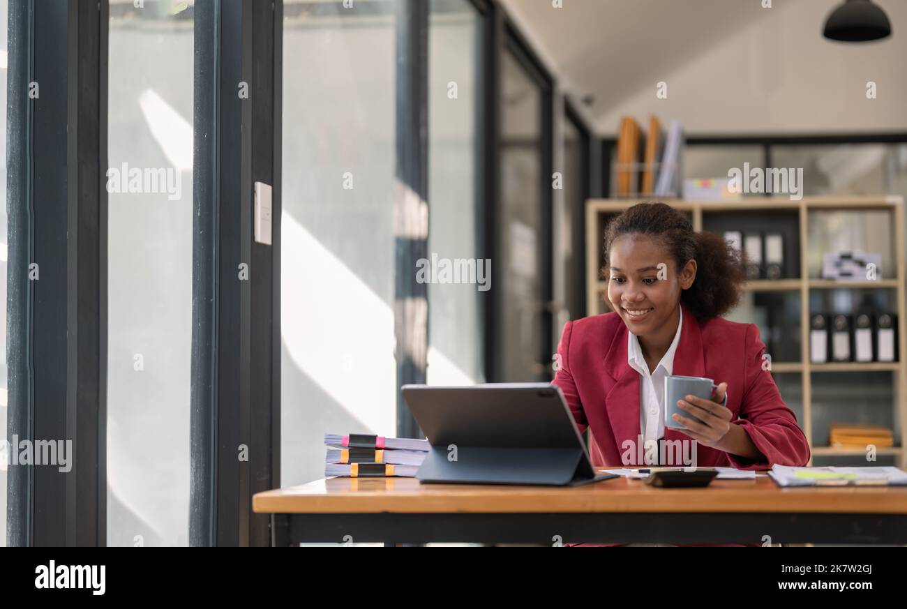 Smiling young African american female Finance Entrepreneur sitting in ...