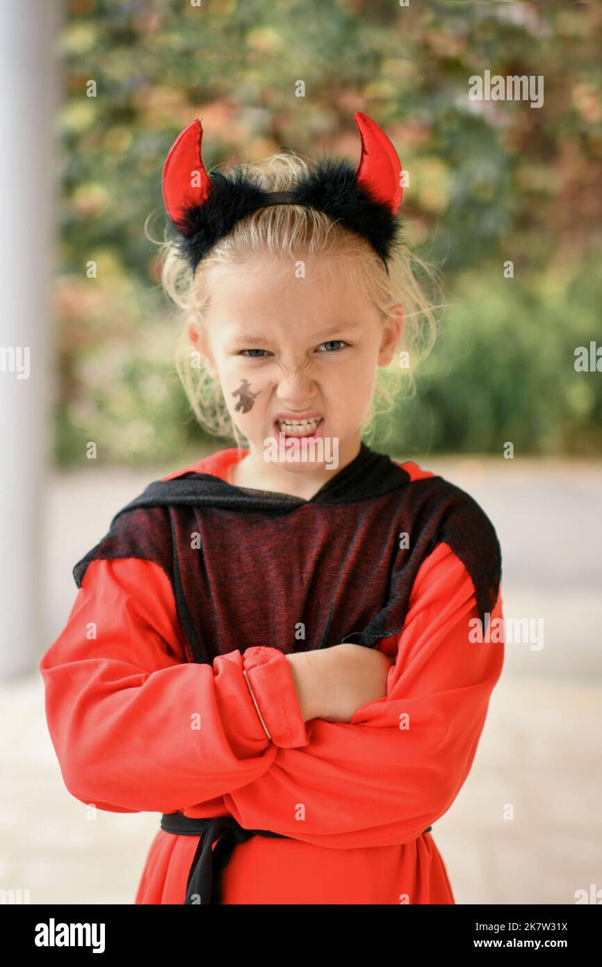Scary girl dressed as a devil with horns Stock Photo - Alamy