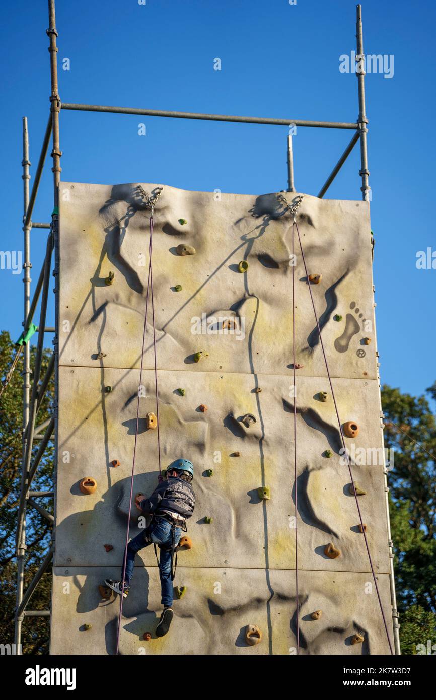 Young boy having fun on an outdoor climbing wall Stock Photo - Alamy