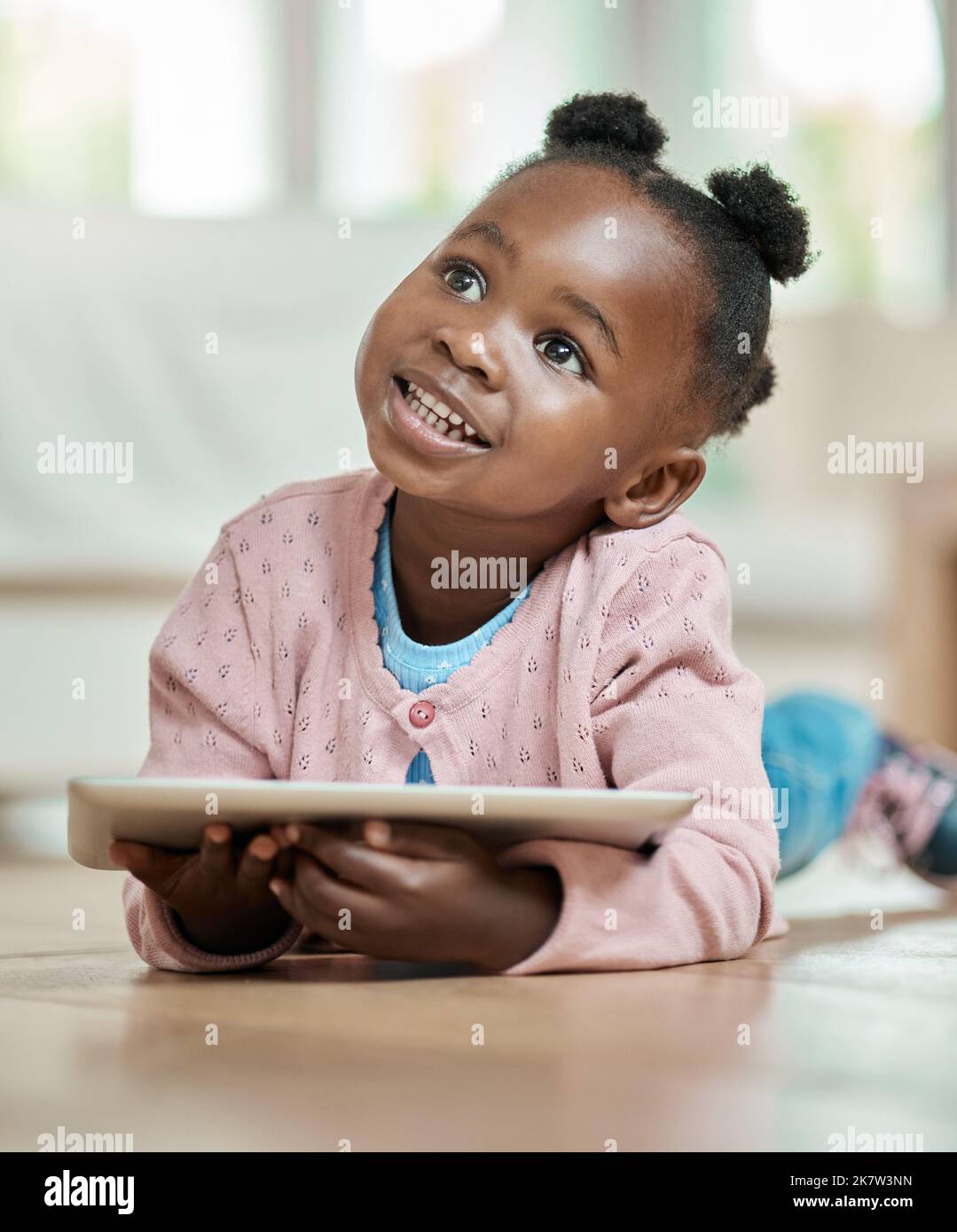 Shes such a tech-savvy kid. Full length shot of an adorable little girl ...