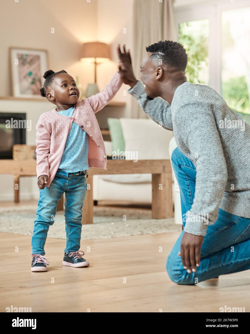 Well done. Full length shot of an adorable little girl high fiving her ...