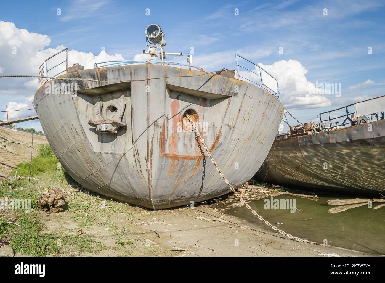 A stranded ship on the bank of the Danube river. View of the bow of a ...