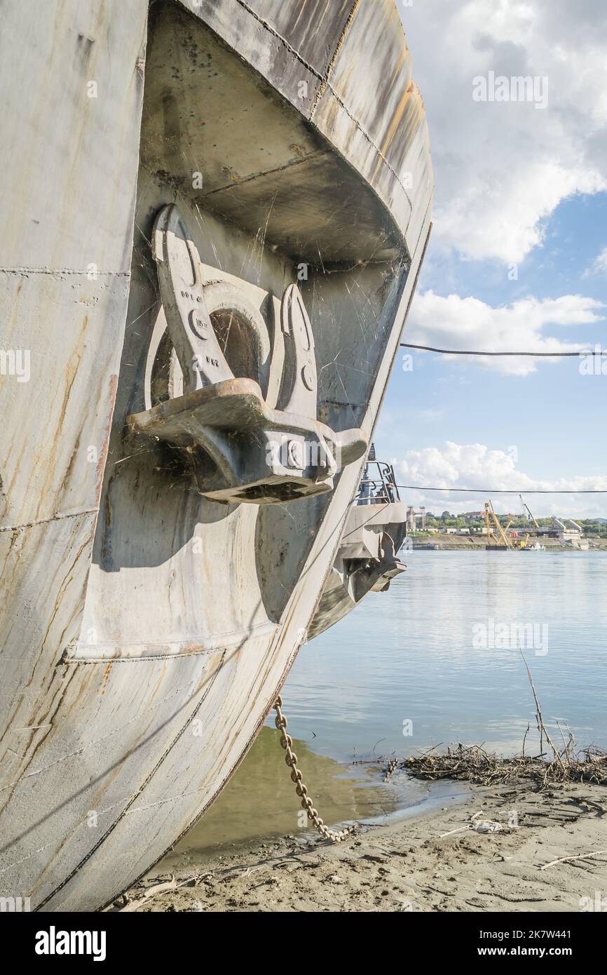 Stranded ship on the bank of the Danube river. The anchor of a stranded ...