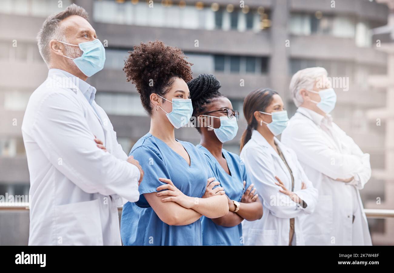 Looking forward to a better tomorrow. a group of doctors standing with ...