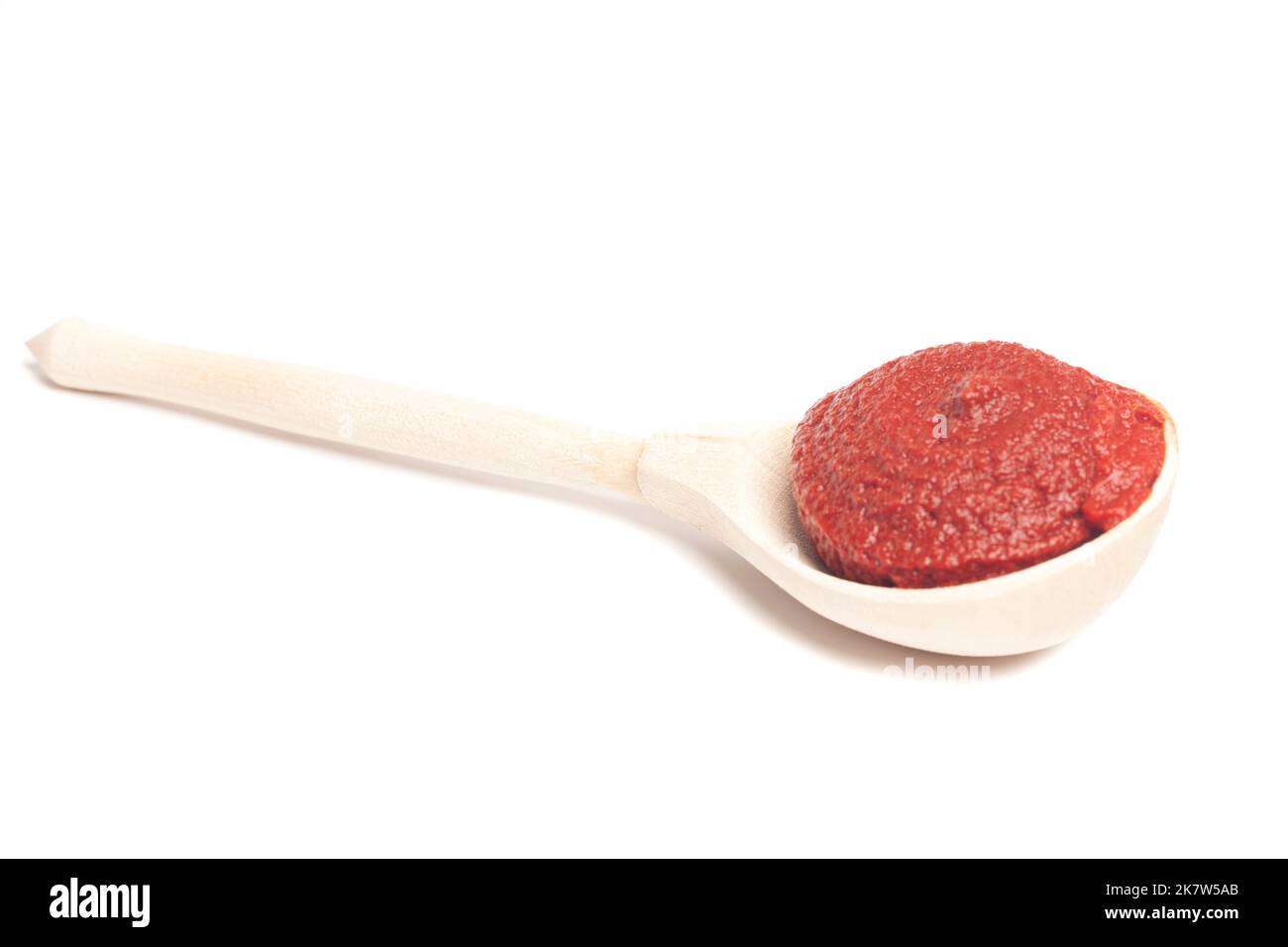 natural tomato paste in wooden spoon isolated on white Stock Photo - Alamy