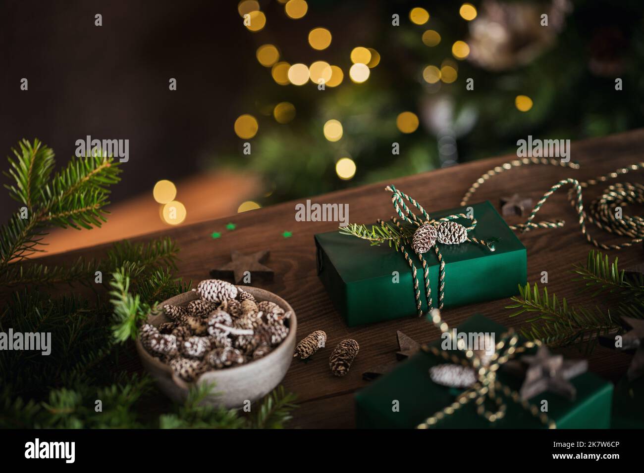 Christmas frame with green gift boxes, wooden star decorations, fir ...