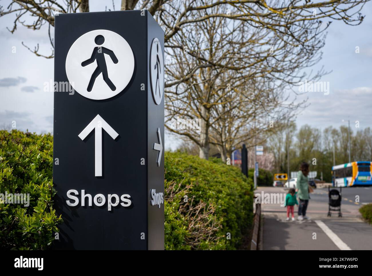 Large directional signage post with arrow and person walking icon ...
