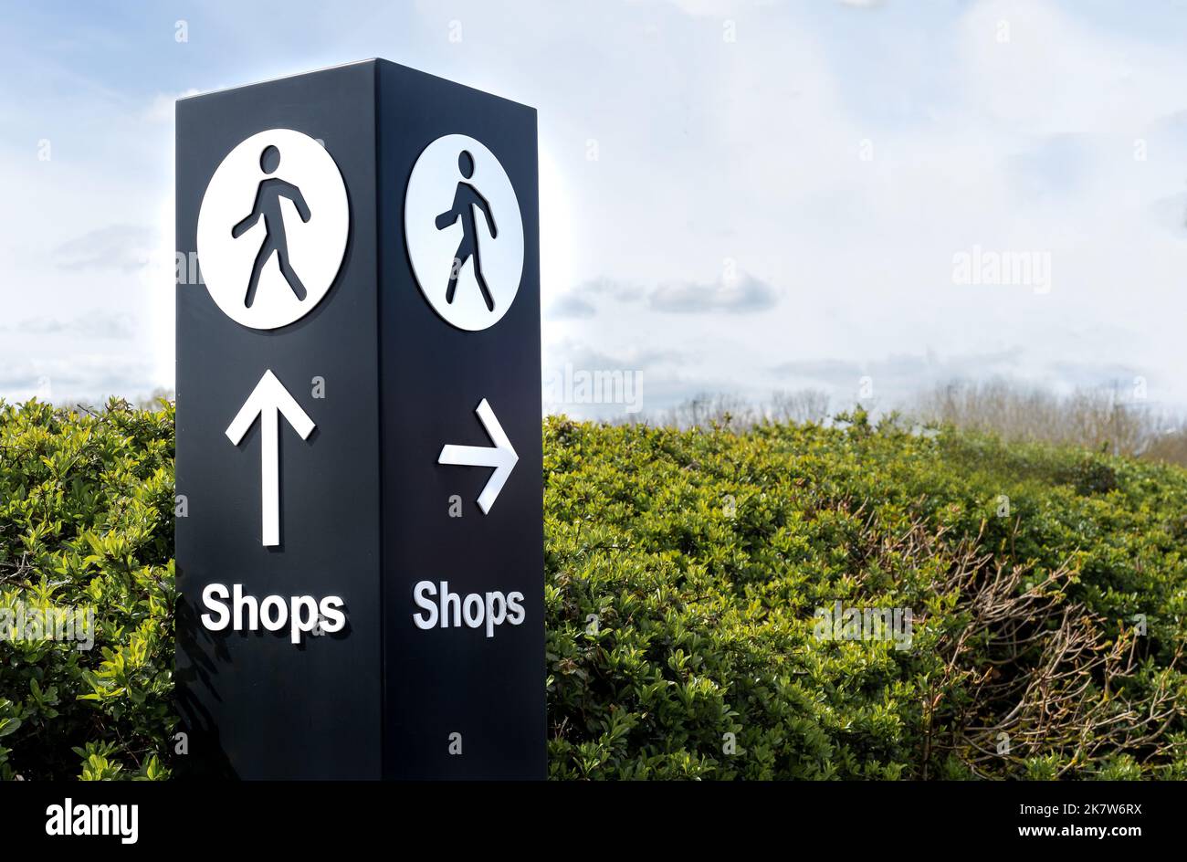Black and white freestanding directional sign post with arrows and ...