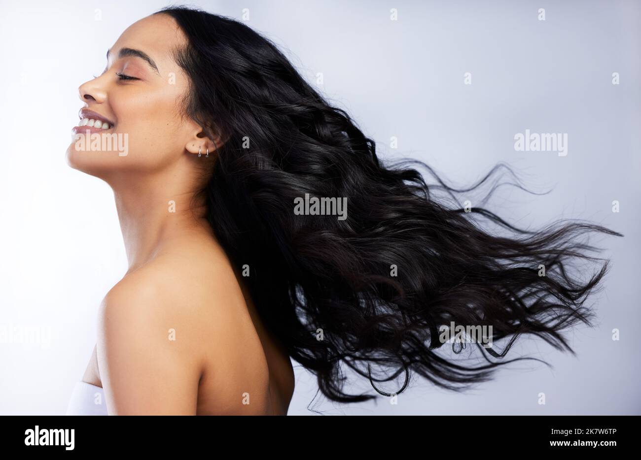 Making the most out of perfectly styled hair. an attractive young woman ...