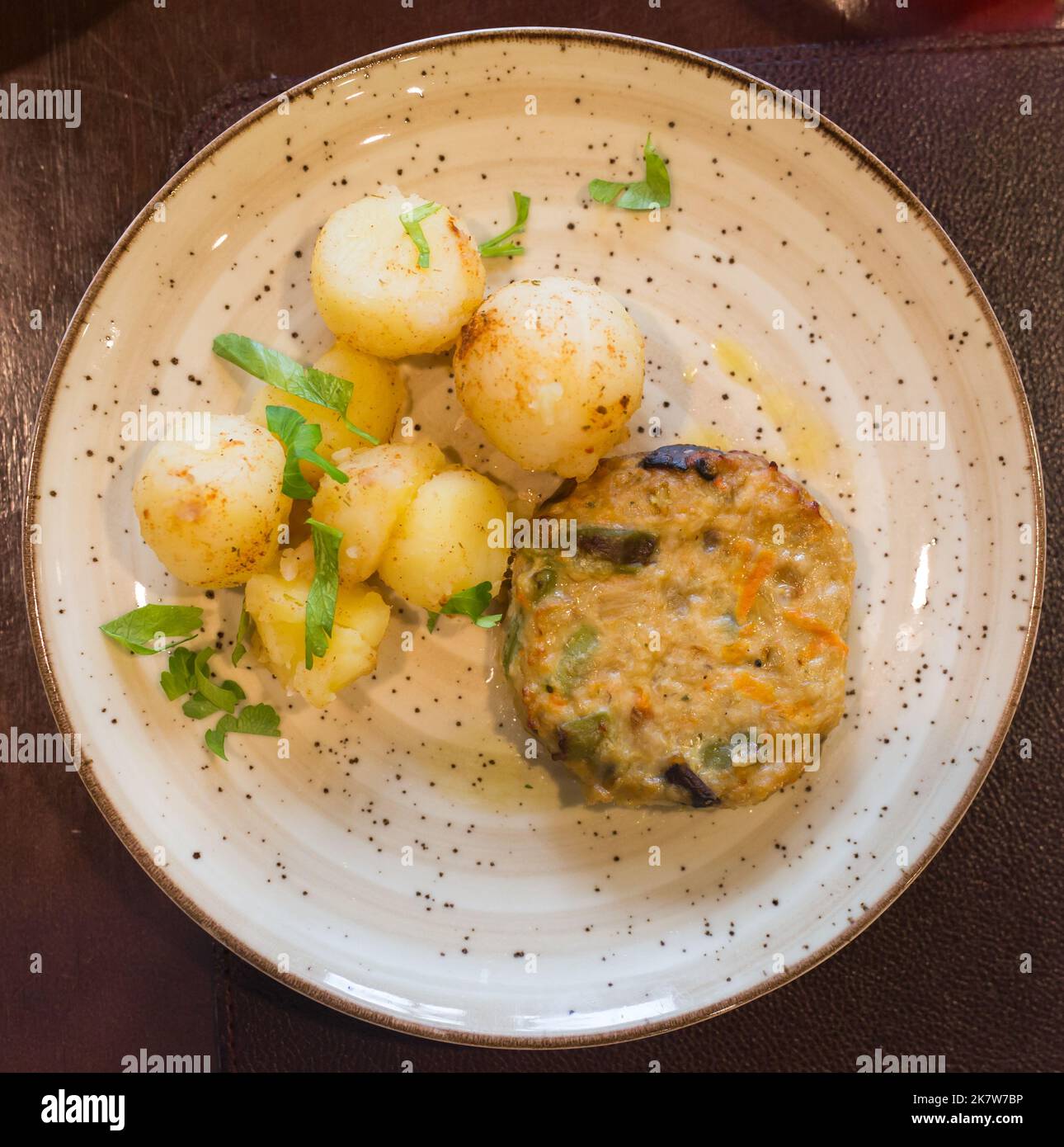 squash burger with boiled potatoes on a plate. top view Stock Photo - Alamy