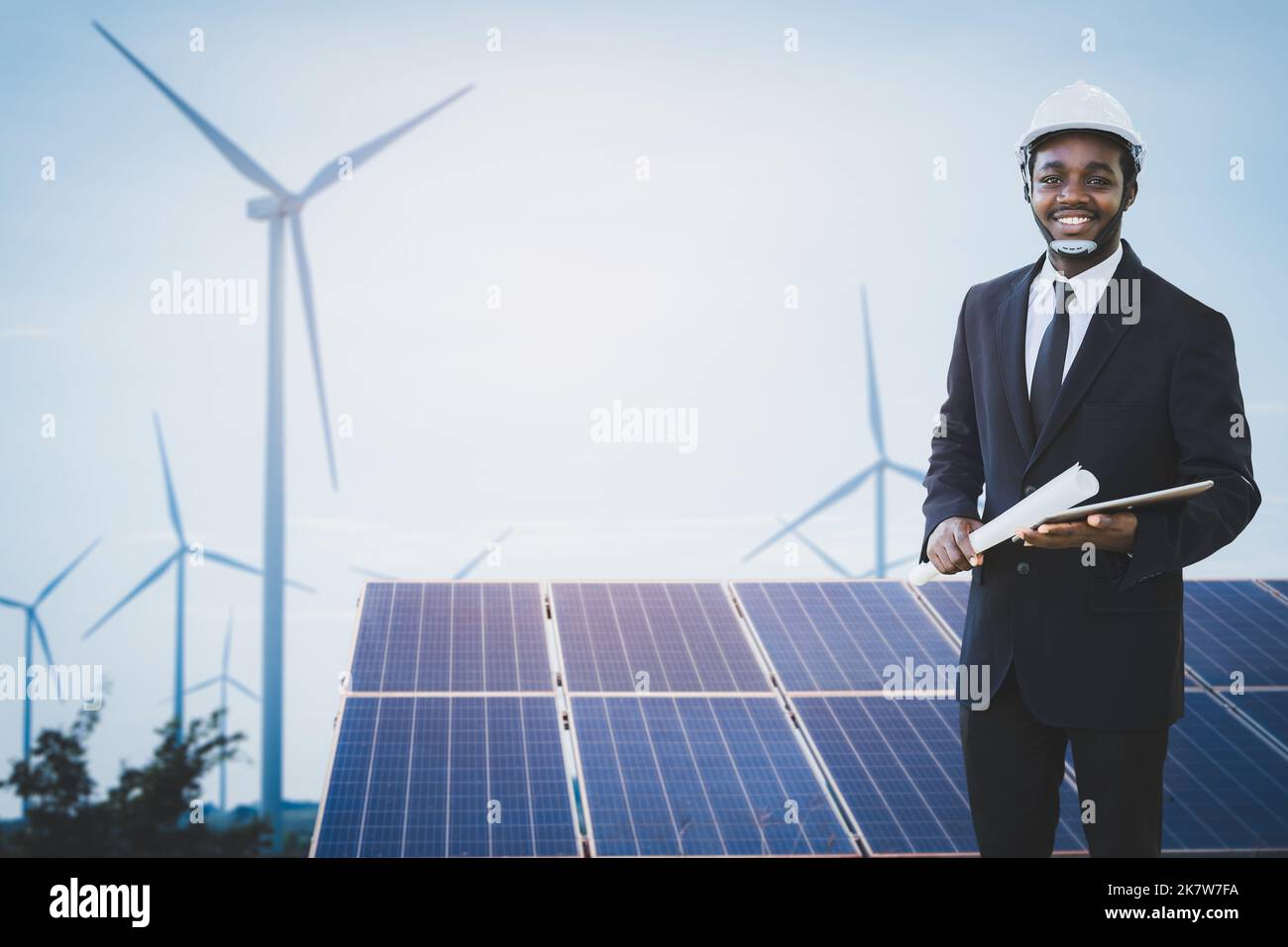 African engineer manager stand holding tablet and blueprint front solar ...