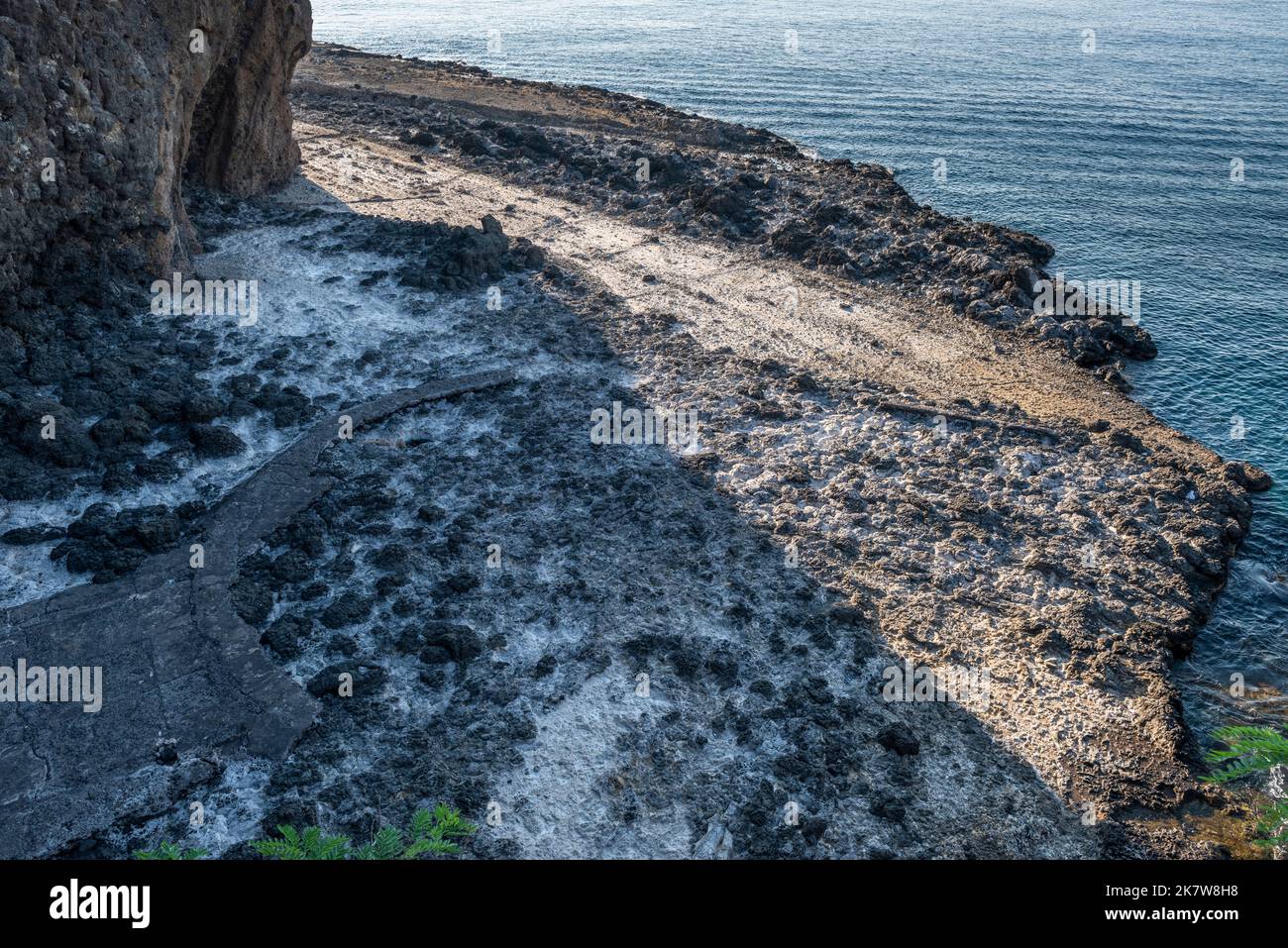 Ancient pillow lava, a volcanic rock formation, visible on the shore at ...