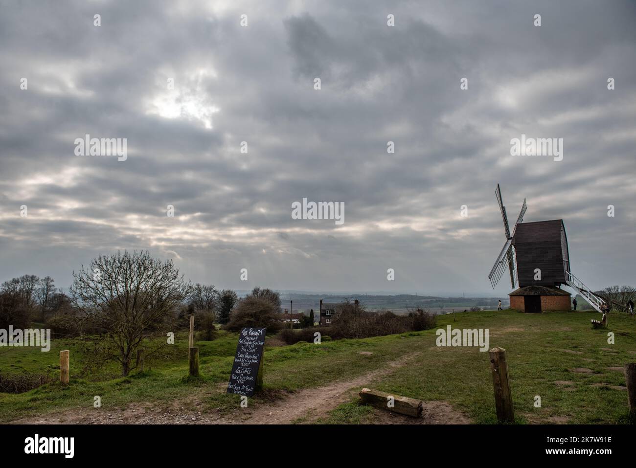 Brill Windmill, with dramatic cloudy skies with the sun shining through ...