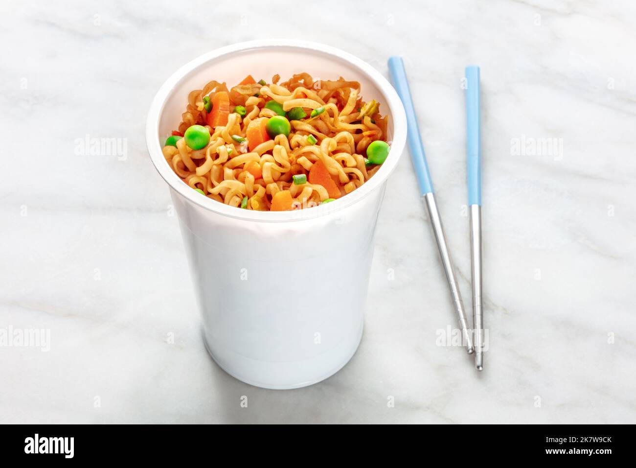 Ramen cup, instant soba noodles in a plastic cup with vegetables, green ...
