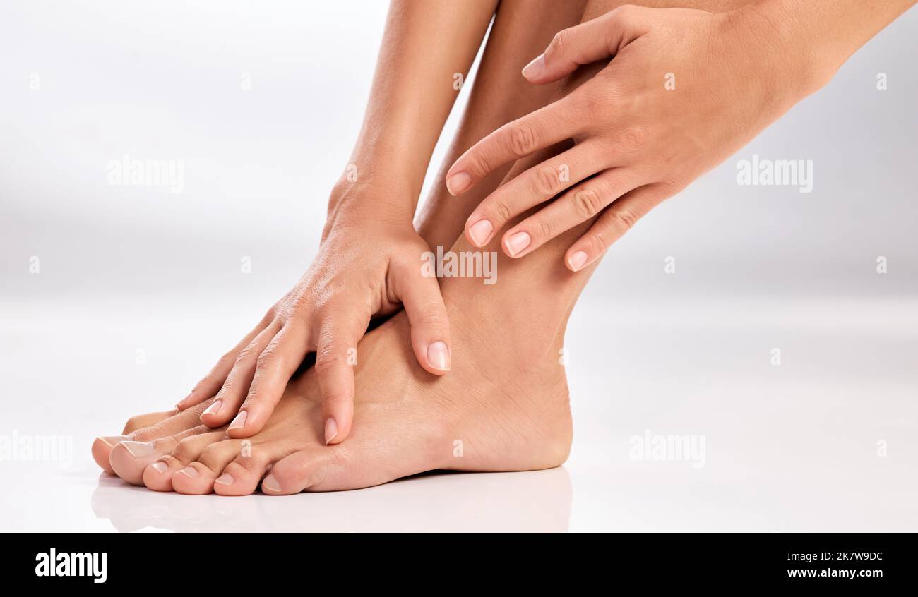I fancy a pedicure. an unrecognizable woman touching her feet in the ...