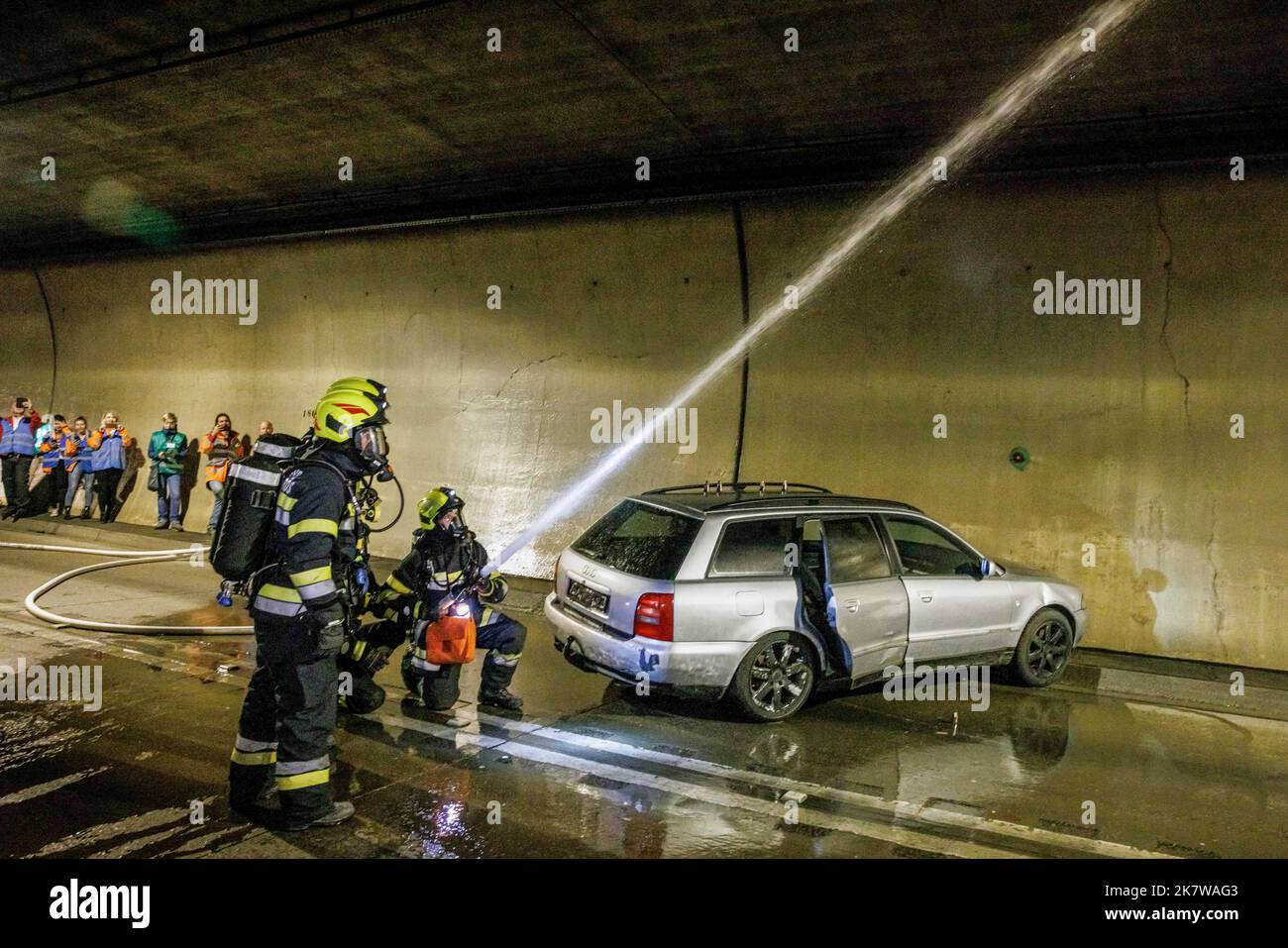 Austrian firemen extinguish a fire at a staged traffic accident during ...